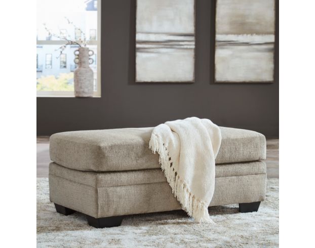 Ashley Stonemeade Taupe Ottoman | Homemakers